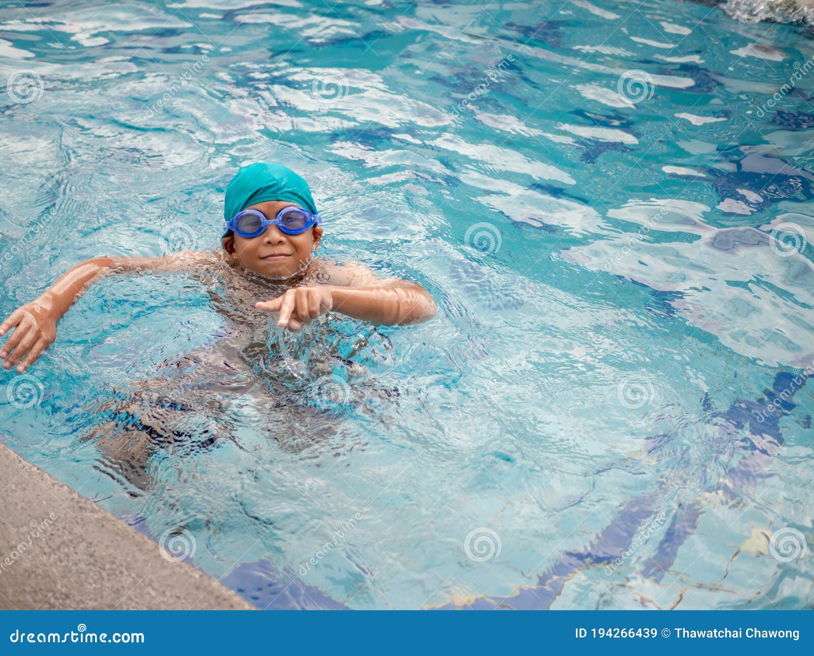 A boy swimming in the pool stock image. Image of hand - 194266439