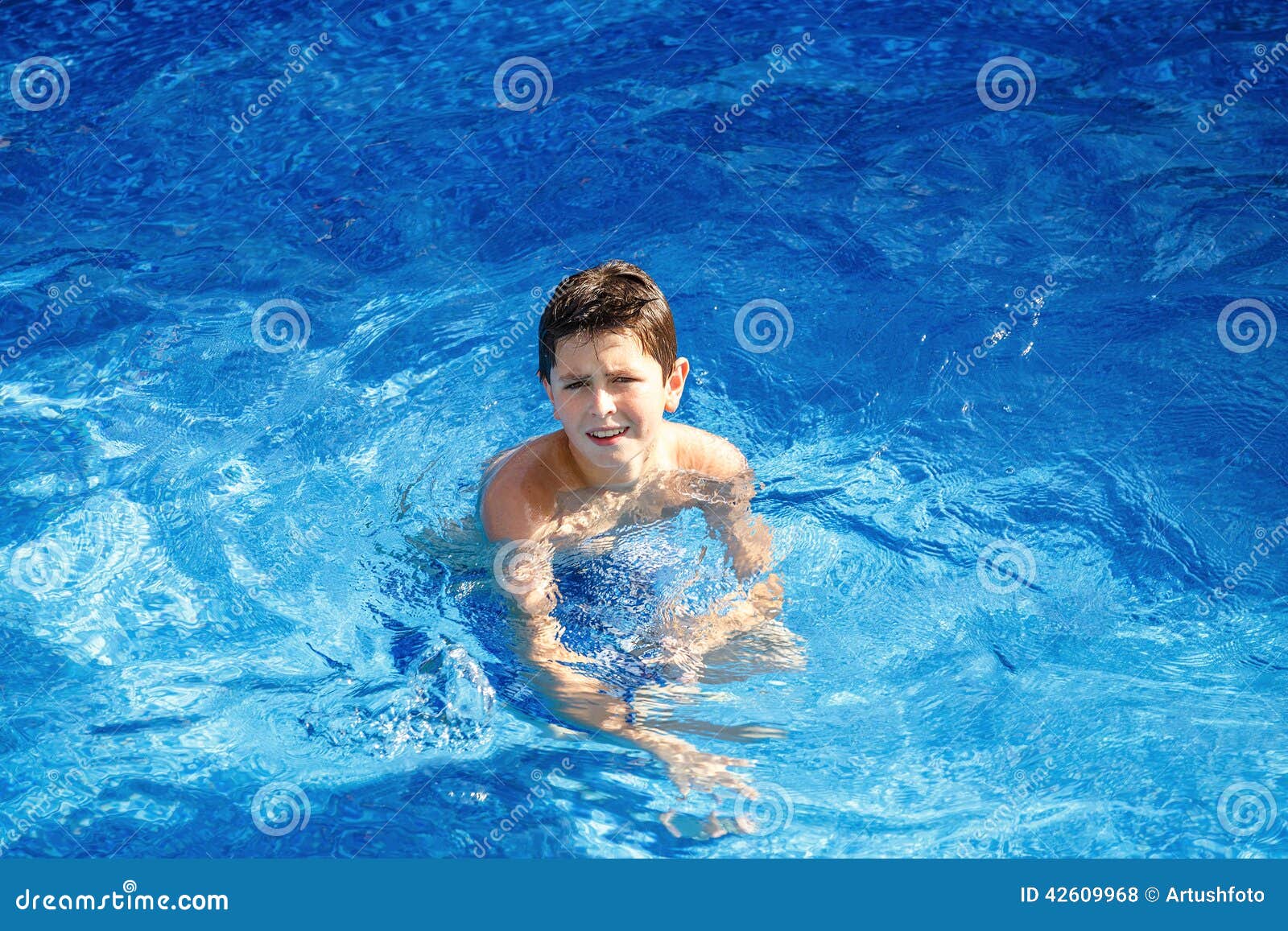 Boy in the swimming pool stock photo. Image of resort - 42609968
