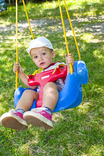 Boy on swing stock image. Image of hanging, cute, swing - 4065215
