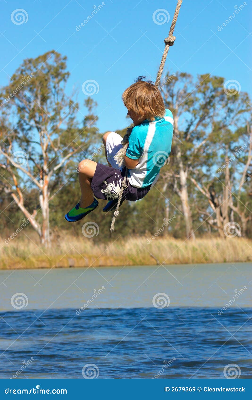 Boy swinging stock image. Image of youth, swinging, lake - 2679369