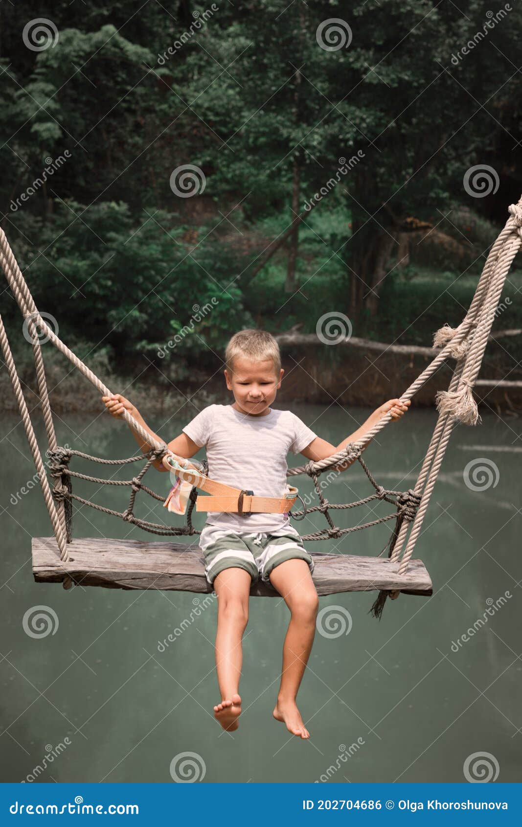 Boy Swinging on a Swing Over the River Stock Photo - Image of motion ...
