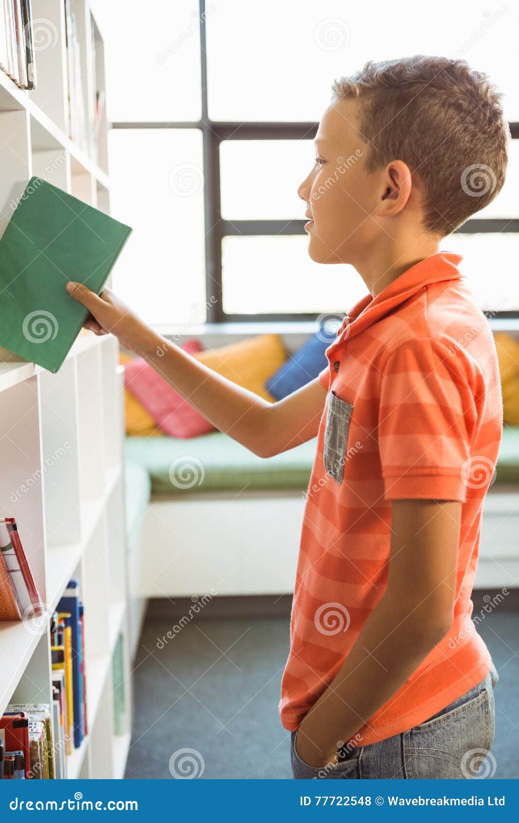 Boy Taking a Book from Bookshelf in Library Stock Photo - Image of ...