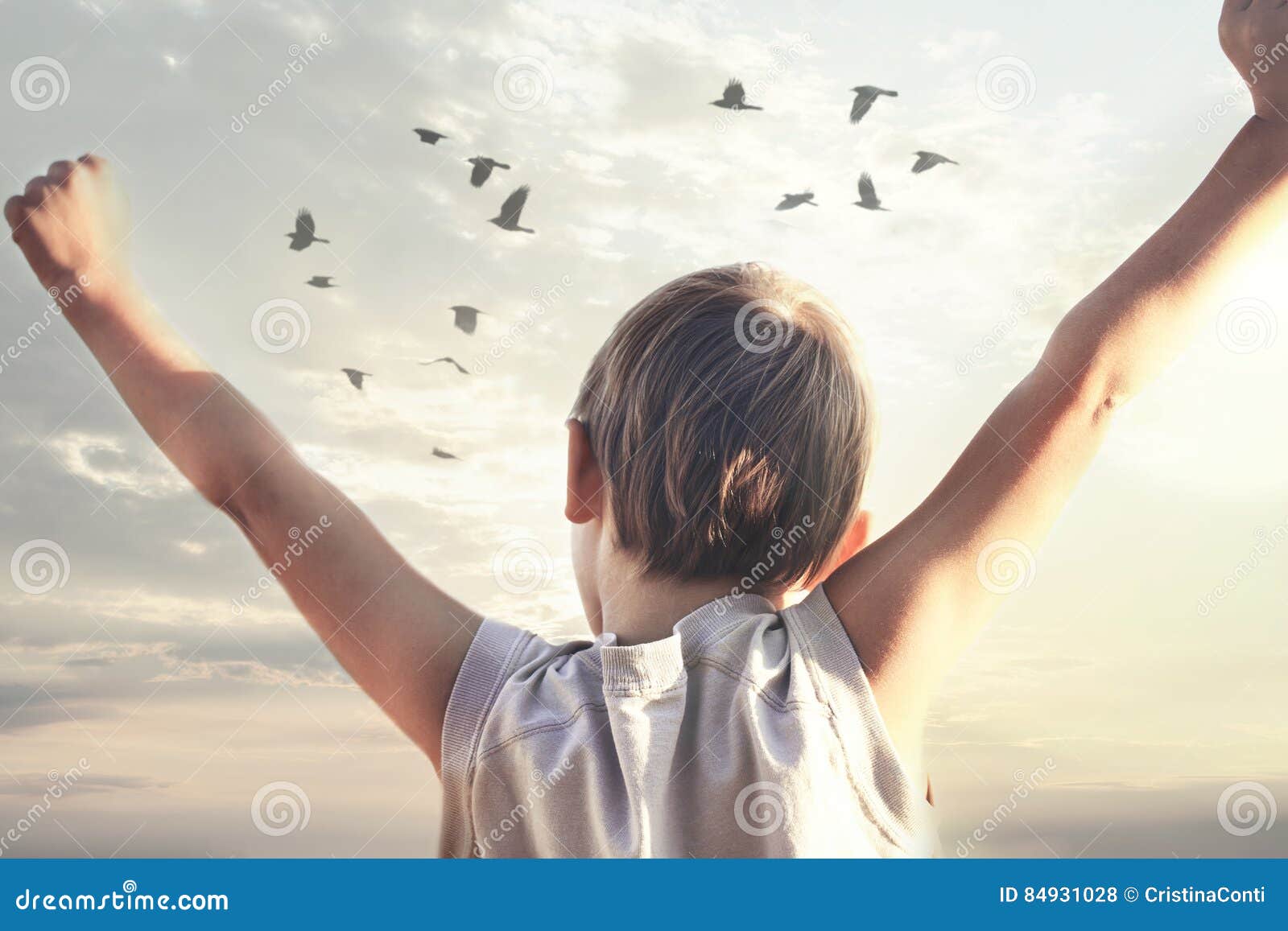 Boy Taking a Breath with Open Arms in Front of a Wonderful Sunset Stock ...