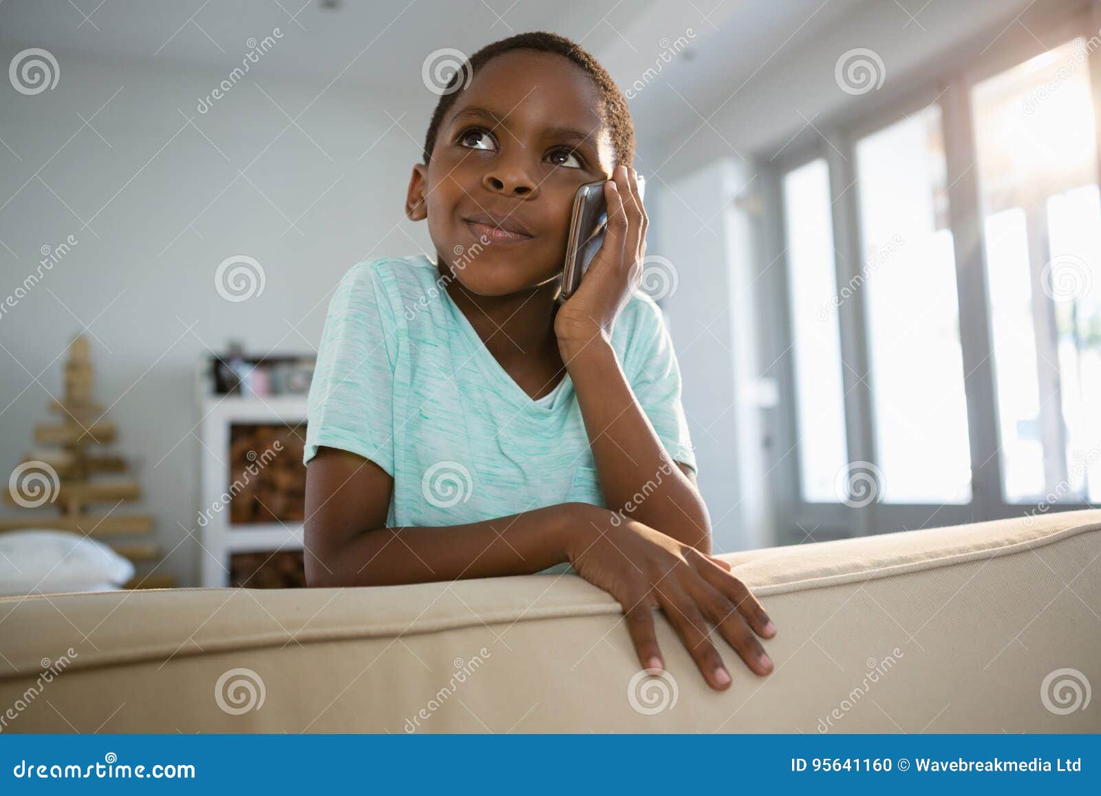 Boy Talking on Mobile Phone in the Living Room Stock Photo - Image of ...