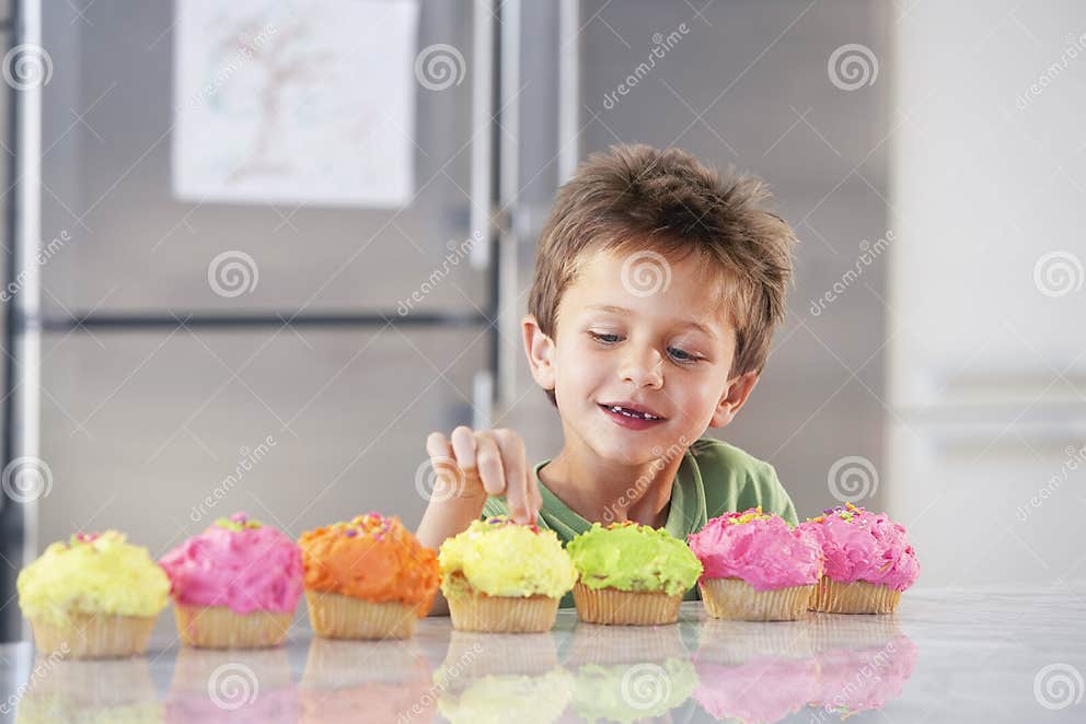 Boy Tasting Cupcakes at Home Stock Photo - Image of innocence ...