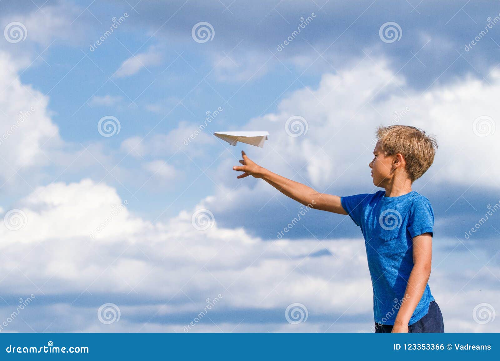 Boy Throwing Paper Plane Against Blue Sky Stock Photo - Image of paper ...