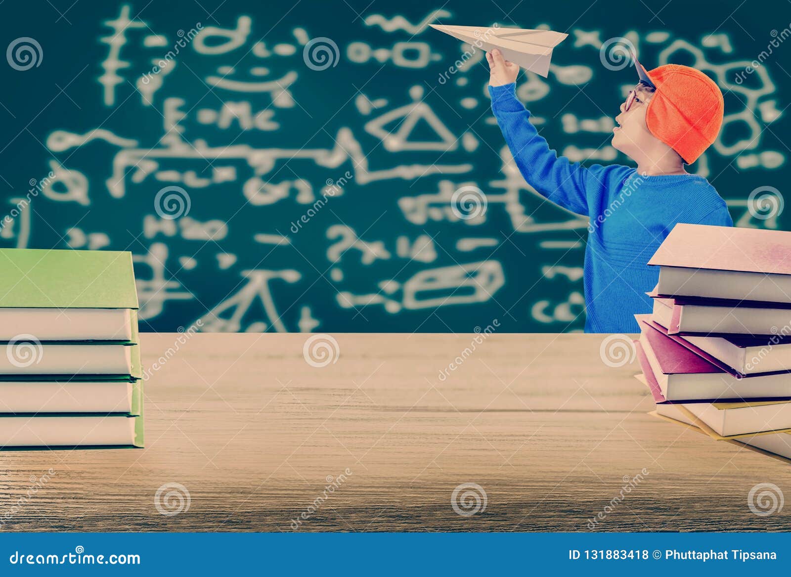 Boy Throwing Paper Planes and Wooden Table with Book Stack, with Stock ...