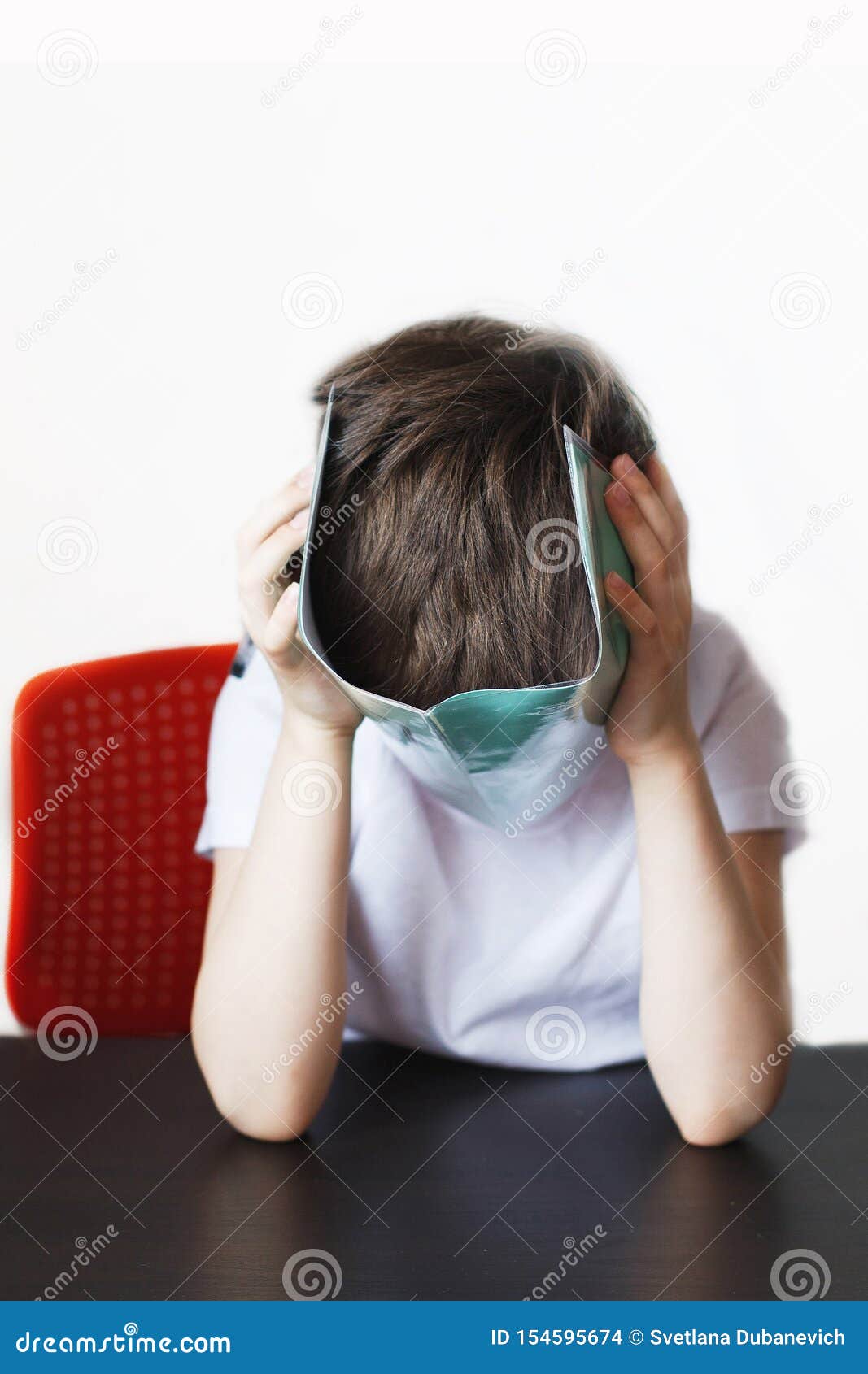 The Boy is Tired of Doing Homework. the Child Covered Face with a ...