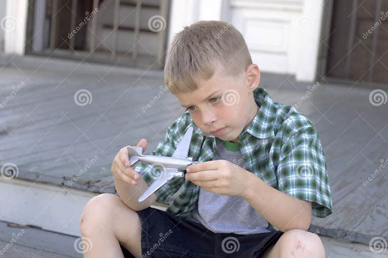 Boy and toy plane stock photo. Image of poor, lesson, daydream - 311362