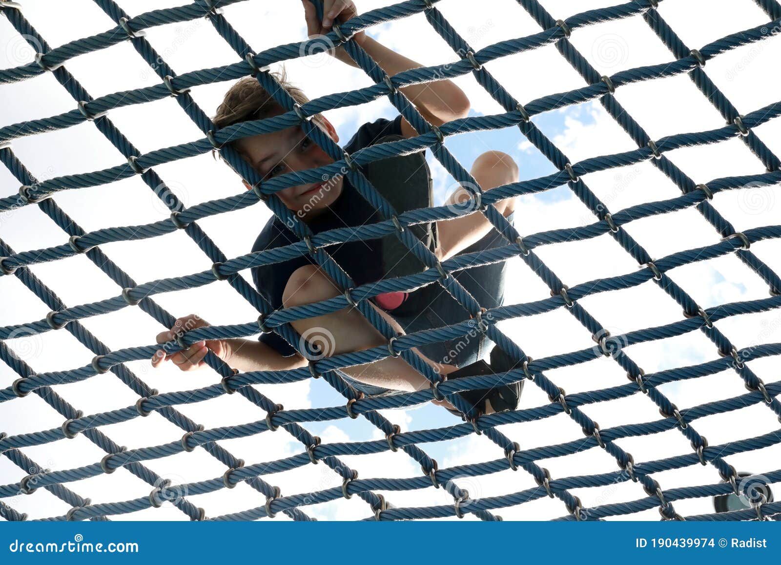 Boy Training Over Netting Obstacle Course Stock Photo - Image of play ...
