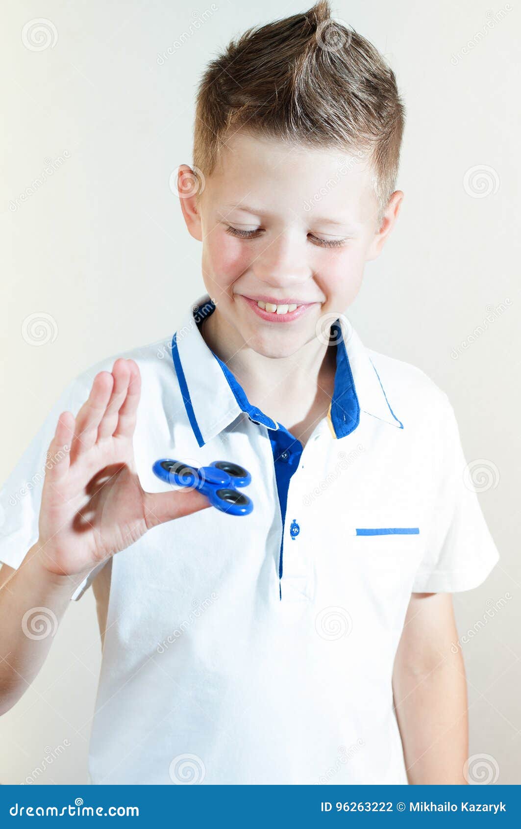The Boy Twists the Spinner in His Hands Stock Photo - Image of mind ...