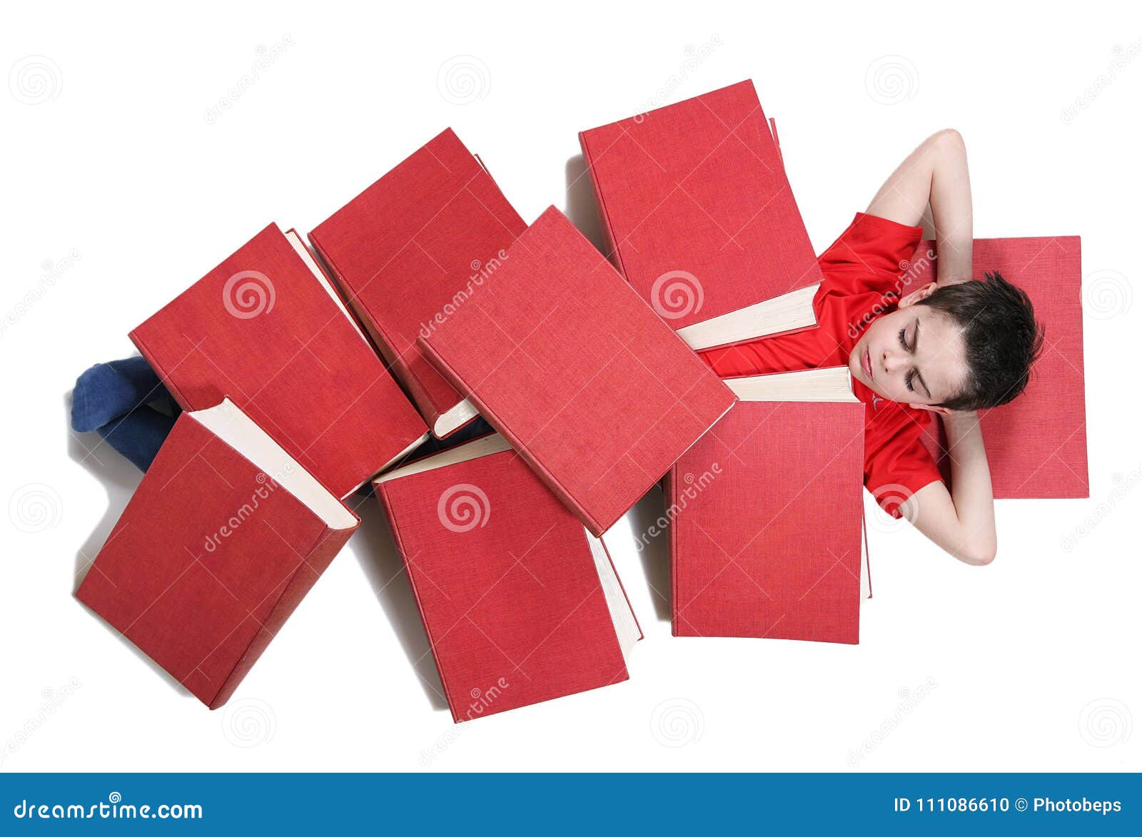 Boy under red books stock photo. Image of white, read - 111086610