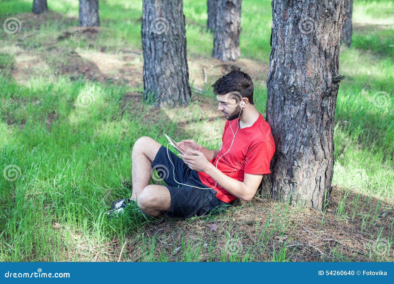 Boy under a tree stock photo. Image of hiking, book, audio - 54260640
