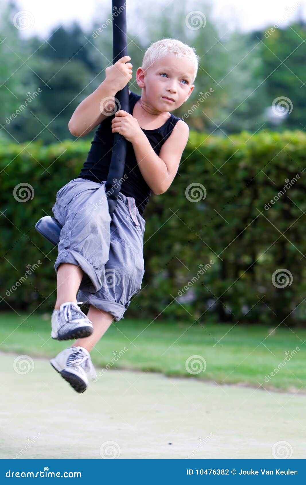 Boy using the cable-way stock photo. Image of ground - 10476382