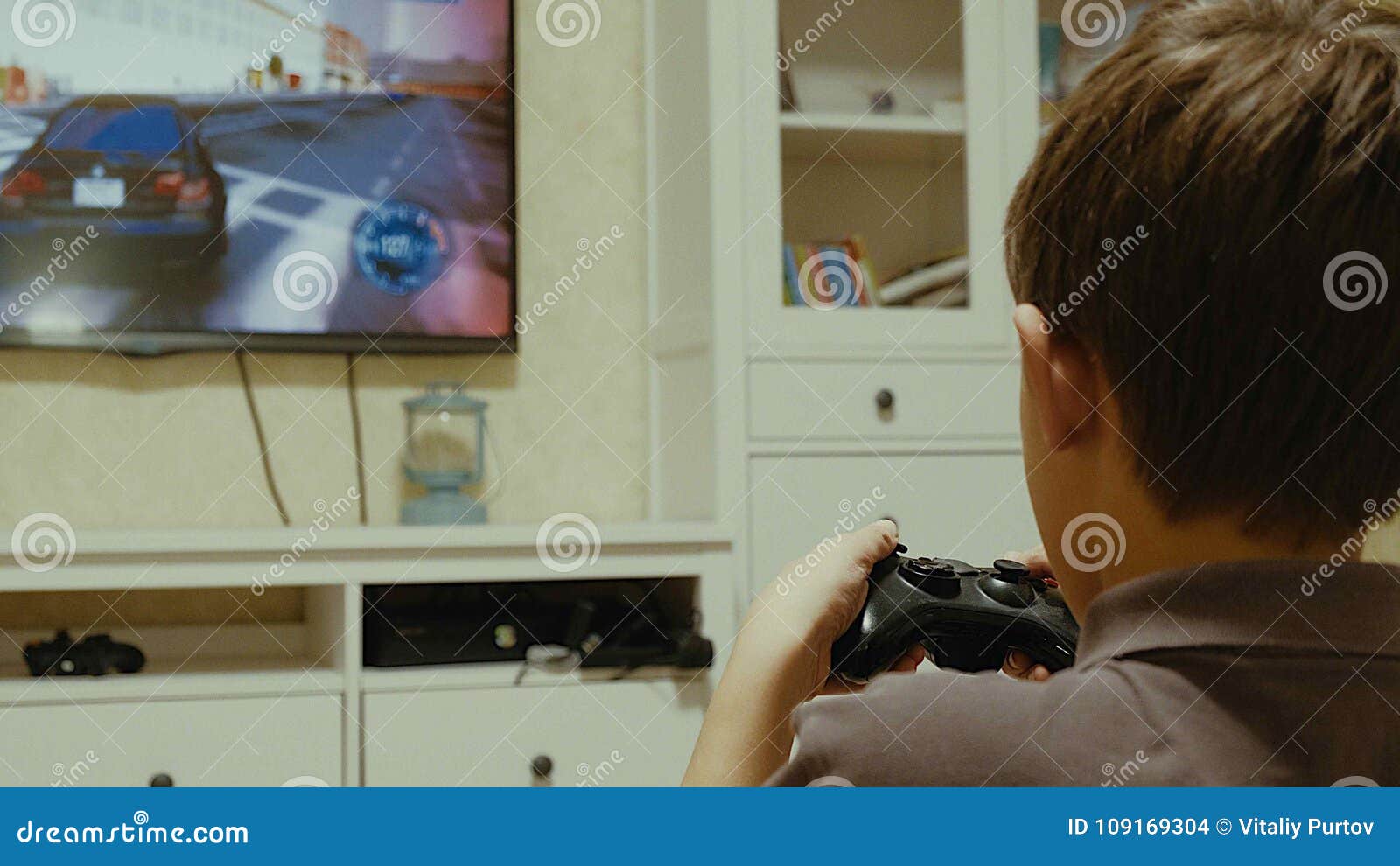 Boy Using a Controller To Play a Video-game Stock Photo - Image of ...