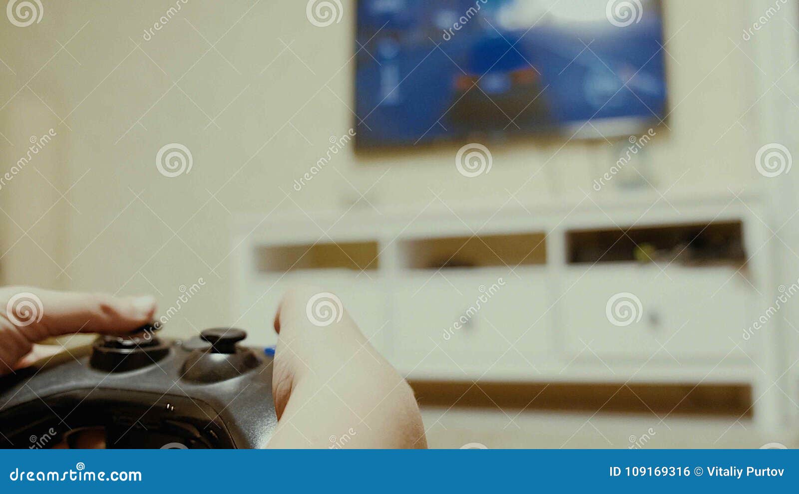 Boy Using a Controller To Play a Video-game Stock Photo - Image of ...