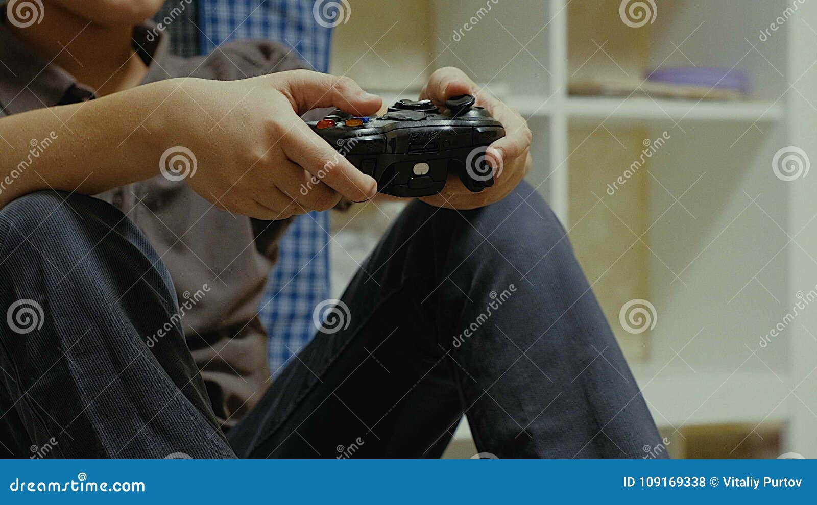 Boy Using a Controller To Play a Video-game Stock Photo - Image of ...