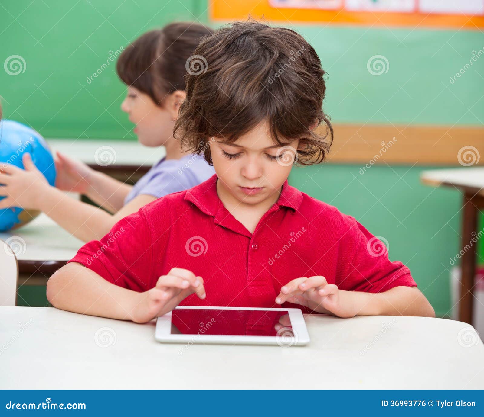 Boy Using Digital Tablet at Desk Stock Photo - Image of connection ...