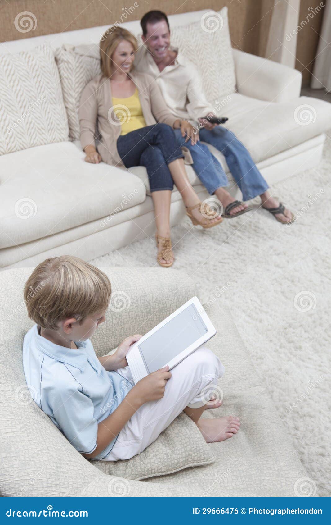 Parents Watching Son Play Video Games In Living Room Front View Royalty ...