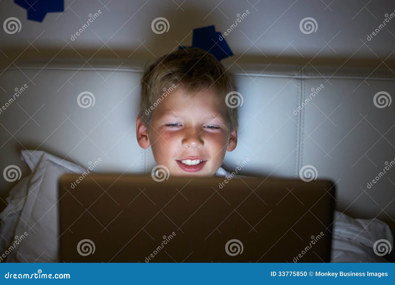 Boy Using Laptop in Bed at Night Stock Photo - Image of laptop, holding ...