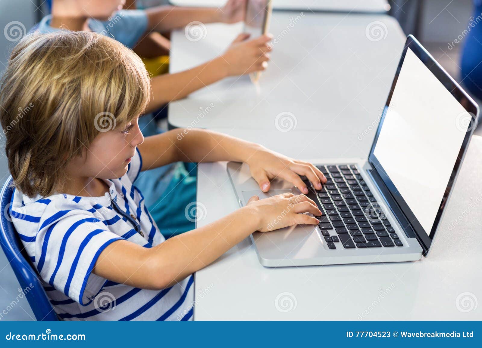 Boy using laptop stock image. Image of indoors, classroom - 77704523
