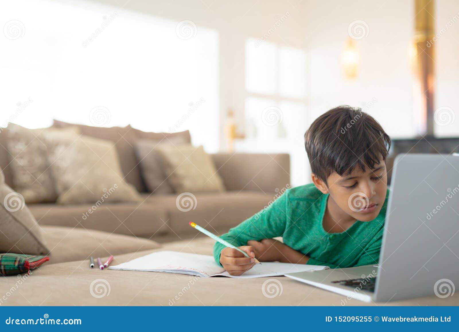 Boy Using Laptop while Drawing a Sketch on Book at Home Stock Image ...