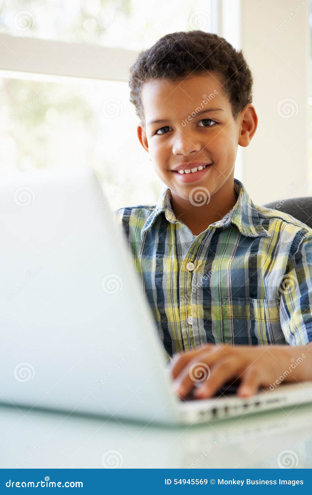 Boy Using Laptop at Home stock image. Image of lounge - 54945569