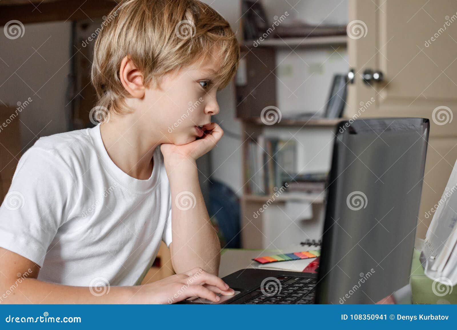 Boy using laptop home stock image. Image of concentrated - 108350941