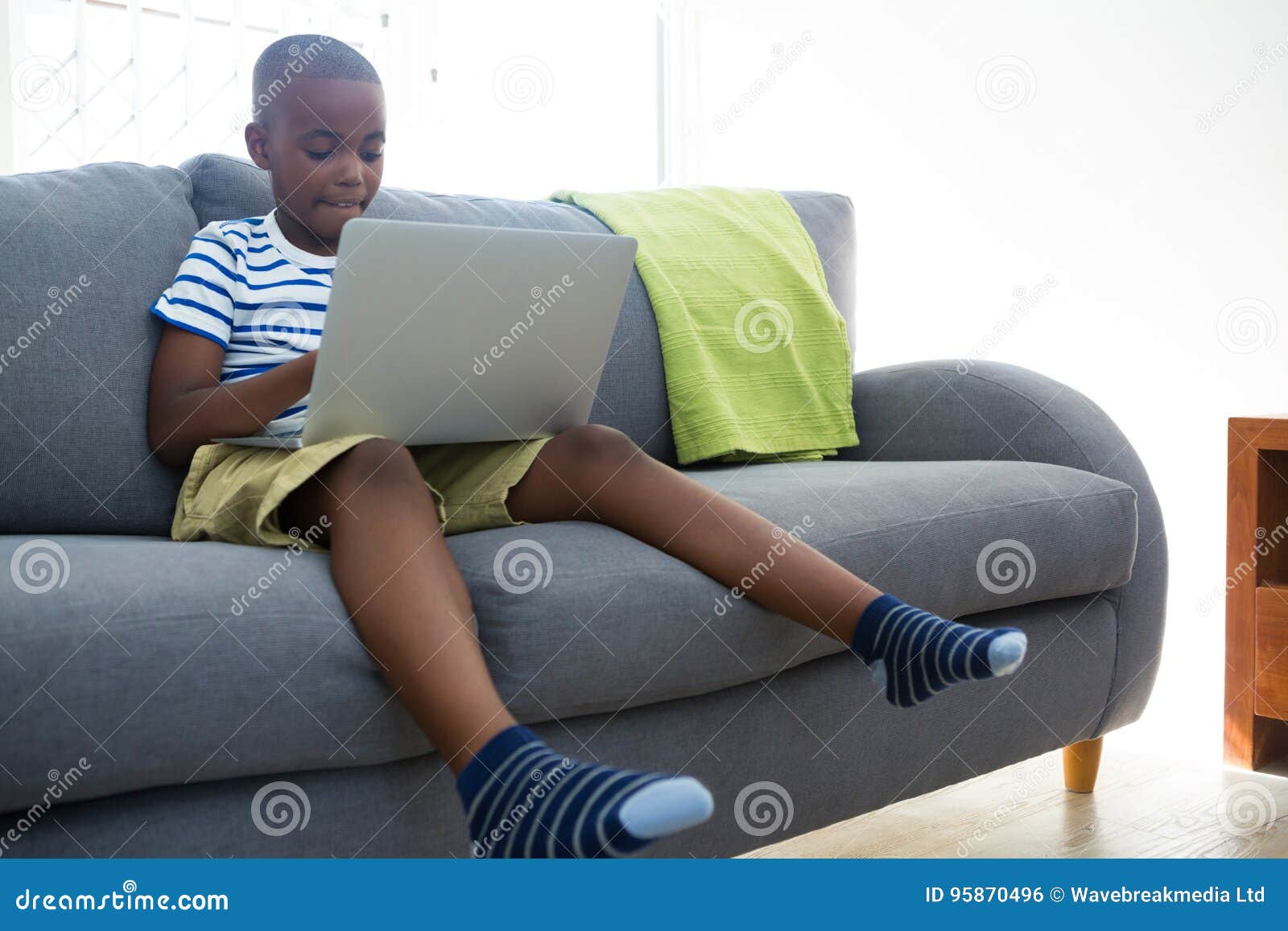 Boy Using Laptop while Sitting on Sofa at Home Stock Photo - Image of ...
