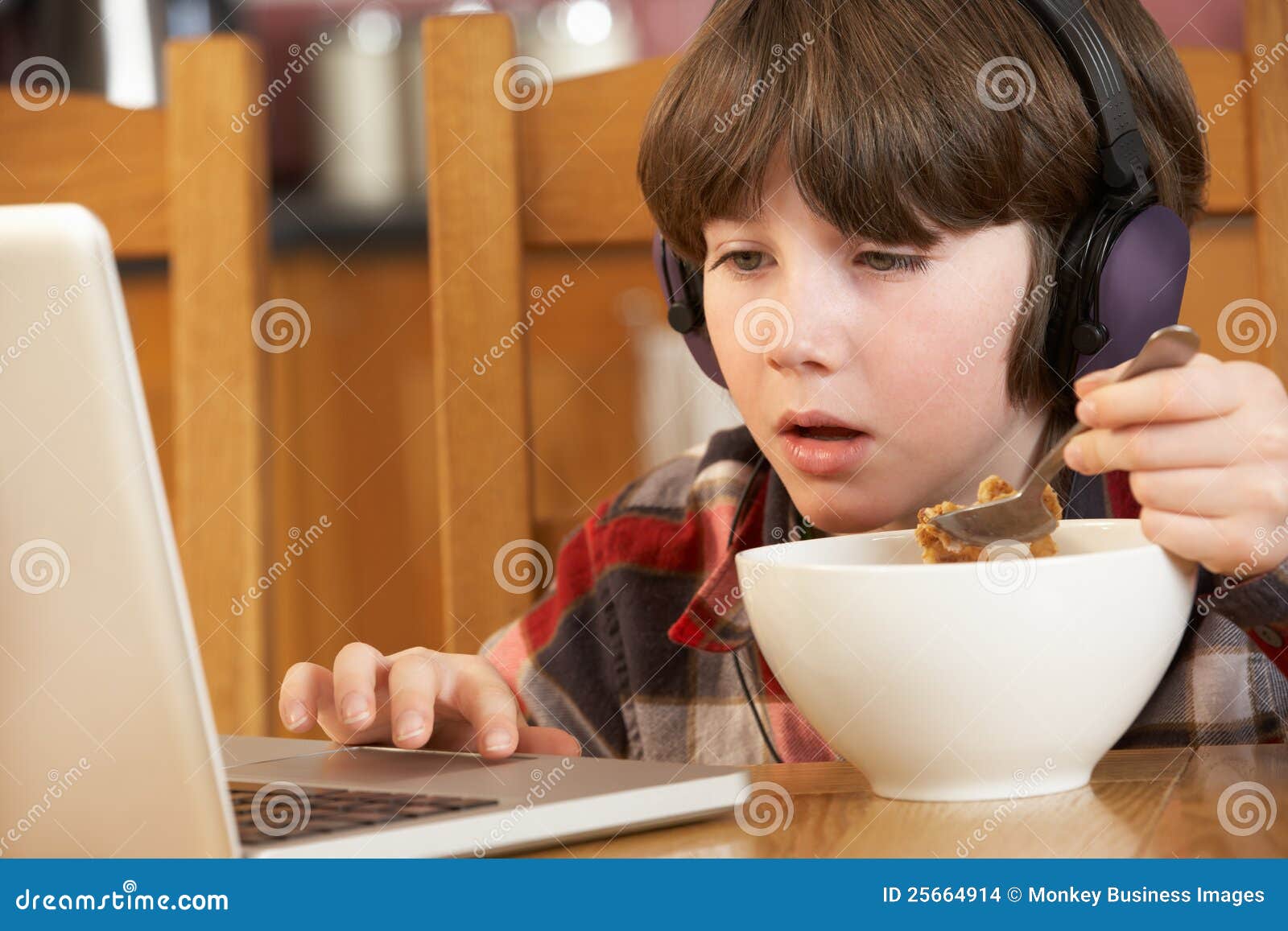 Boy Using Laptop Whilst Eating Breakfast Stock Photo - Image of home ...