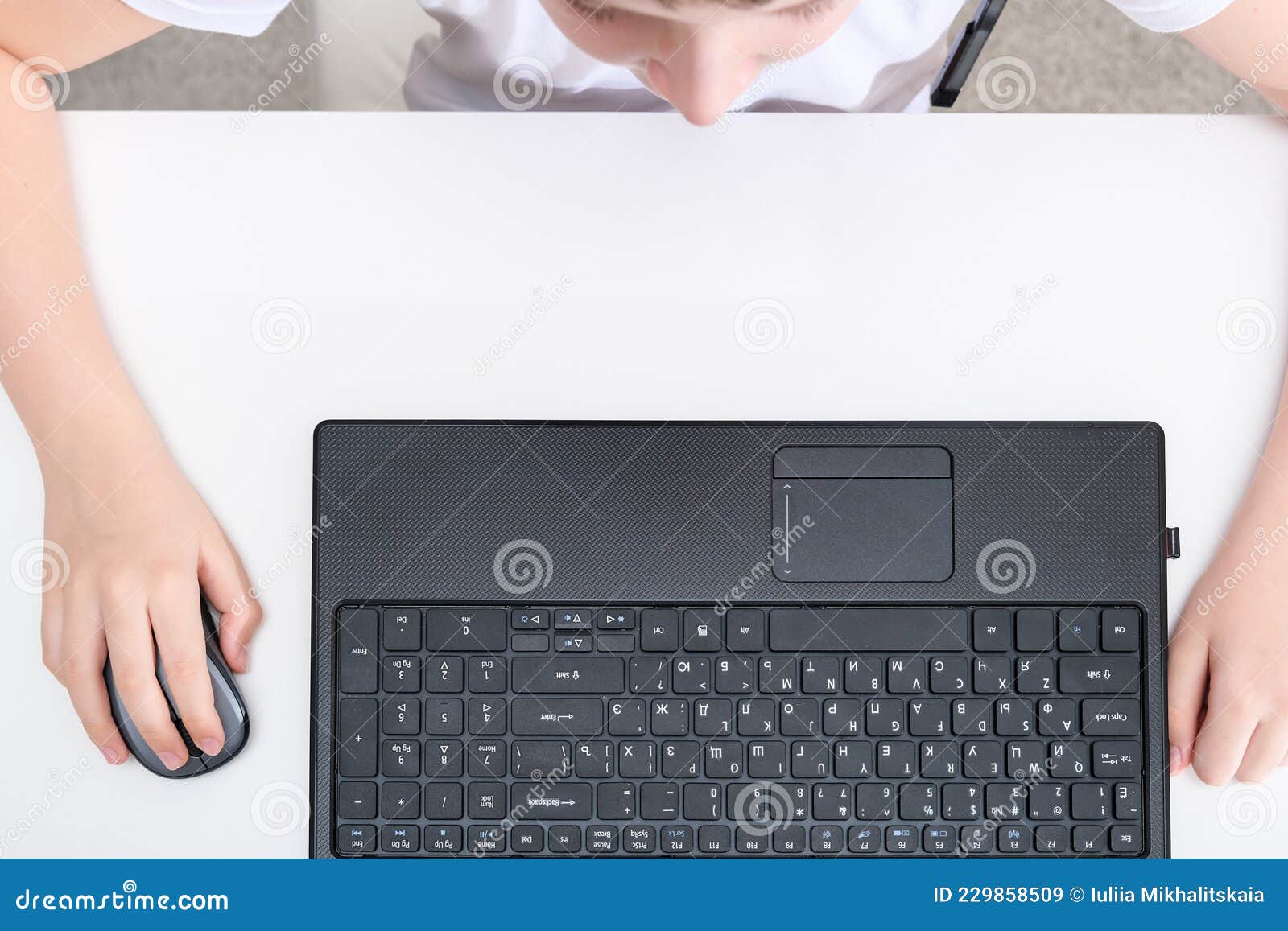 A Boy Using Laptop on a White Table, Top View Stock Image - Image of ...