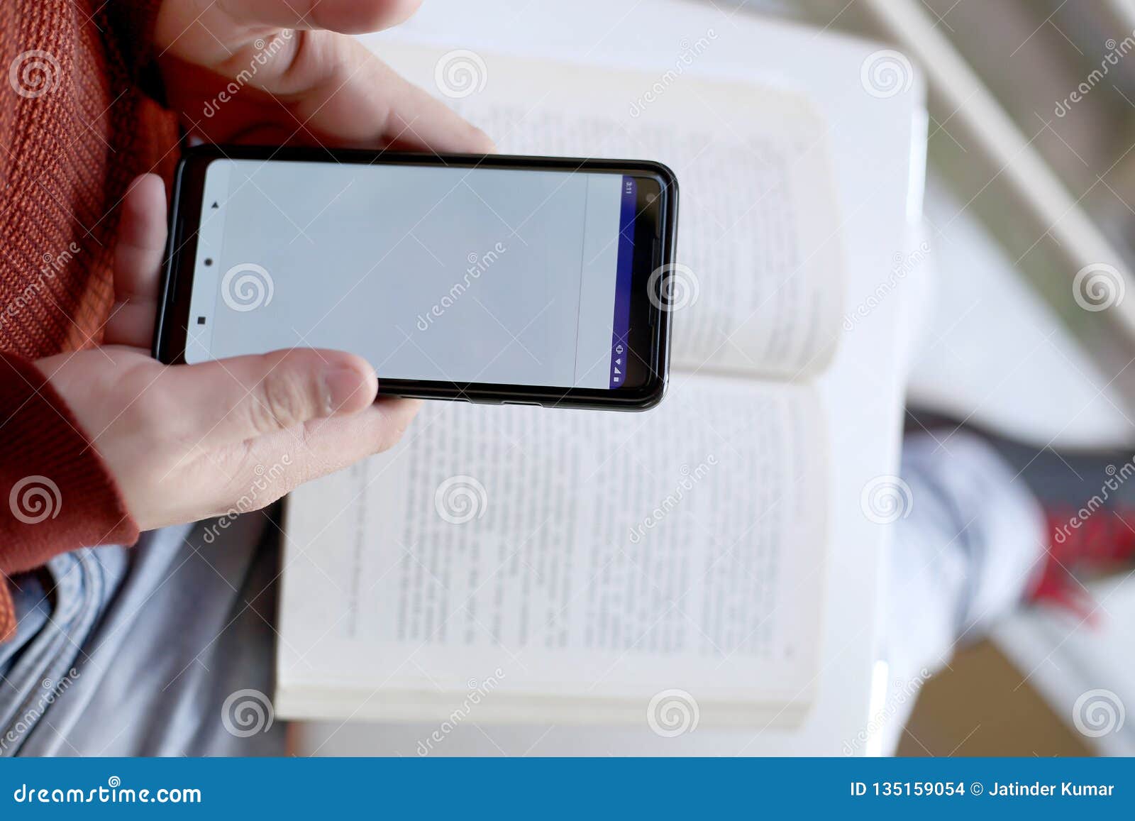 Boy is Using Phone with Open Book on the Table Stock Photo - Image of ...