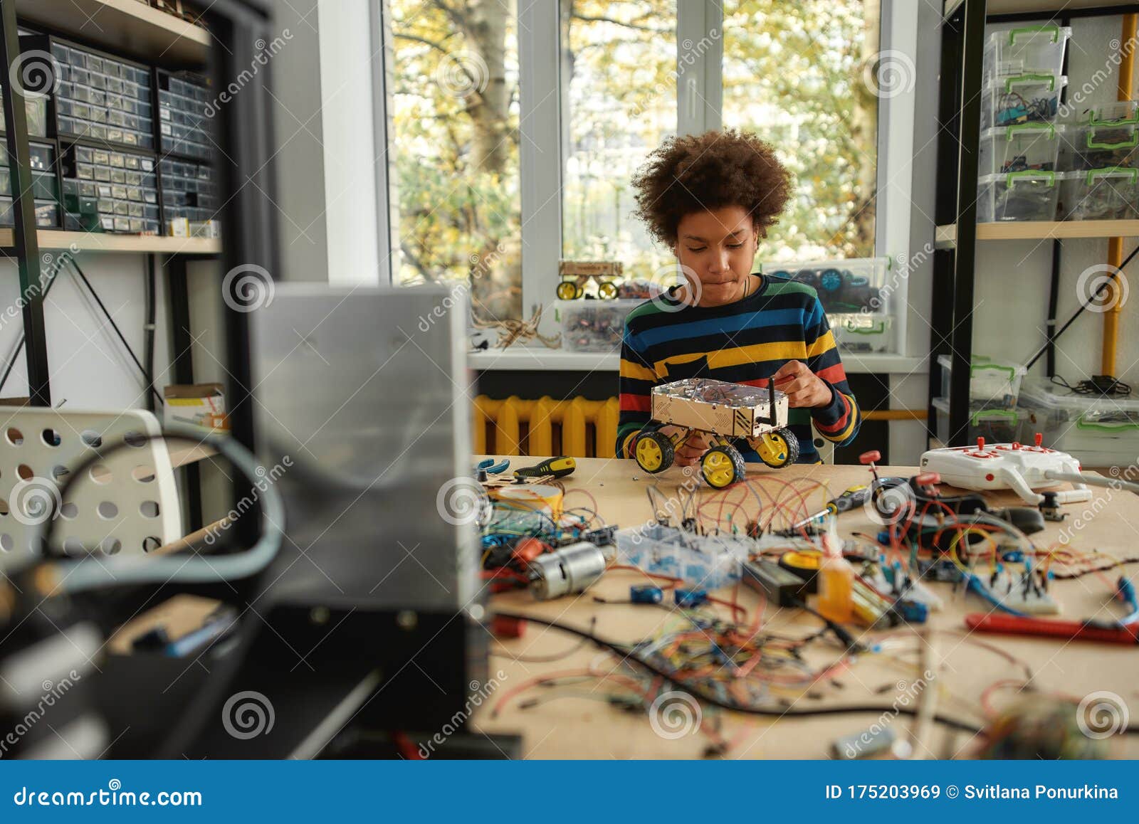 Your Potential. Boy Using Screwdriver while Fixing Bolts on a Robot ...