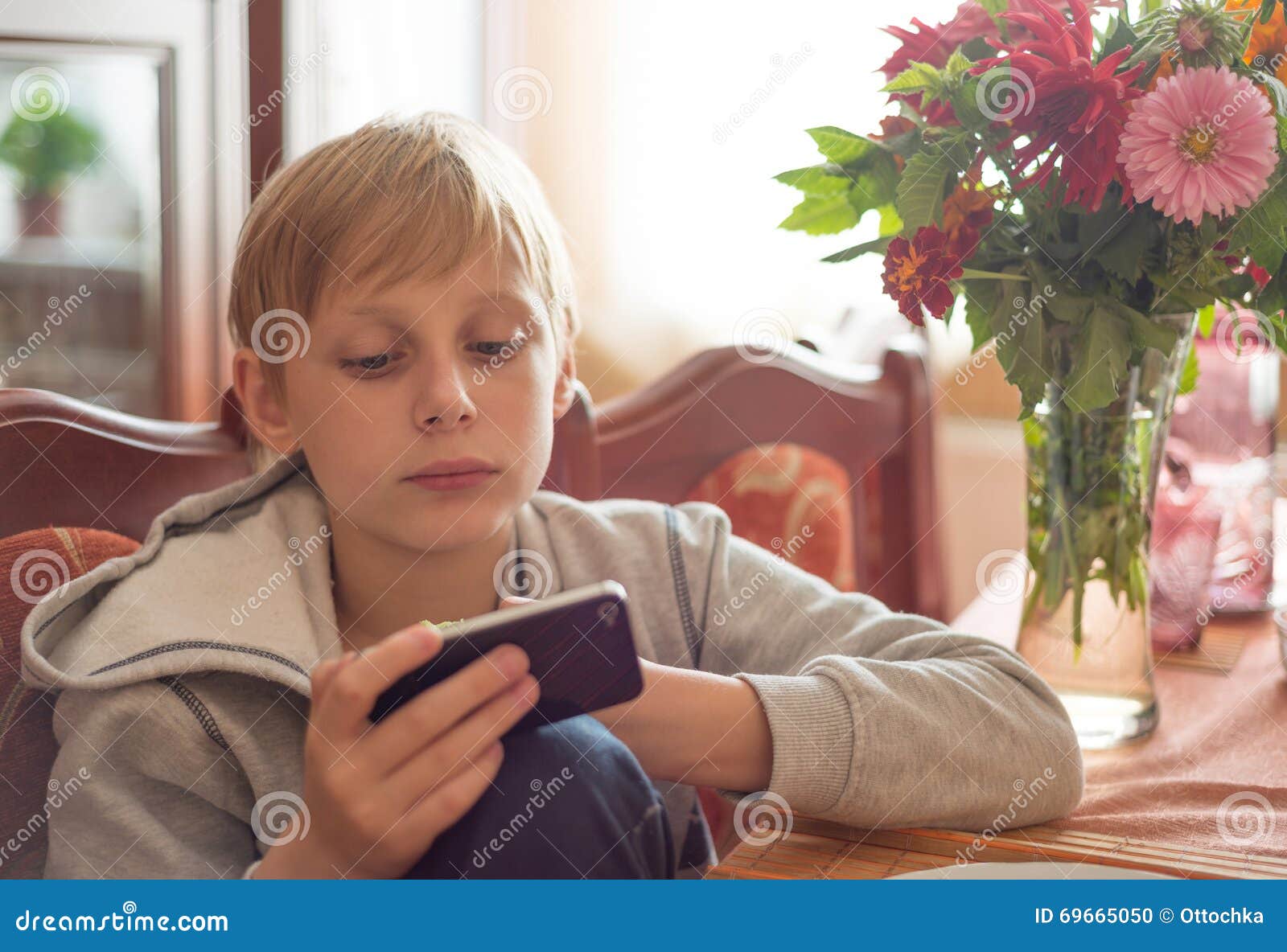 Boy is Using a Smartphone at Home Stock Photo - Image of blonde ...