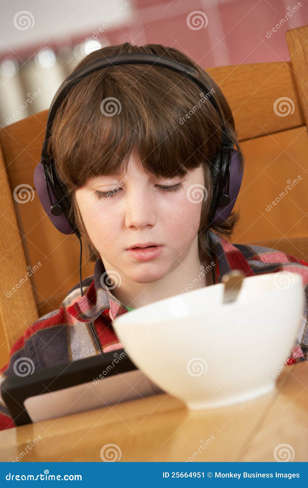 Boy Using Tablet Computer Whilst Eating Breakfast Stock Image - Image ...