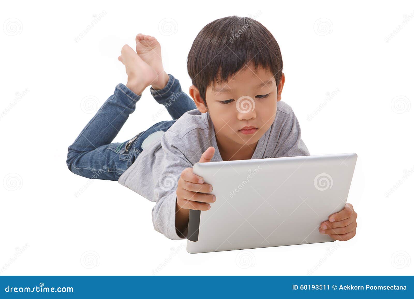 Boy Using Tablet while Lying Stock Image - Image of floor, touchscreen ...