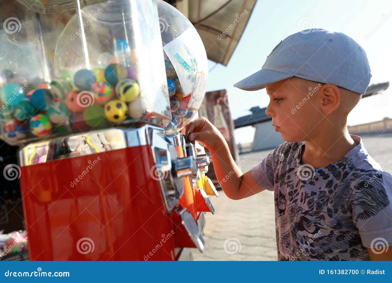 Boy using vending toys stock photo. Image of holding - 161382700