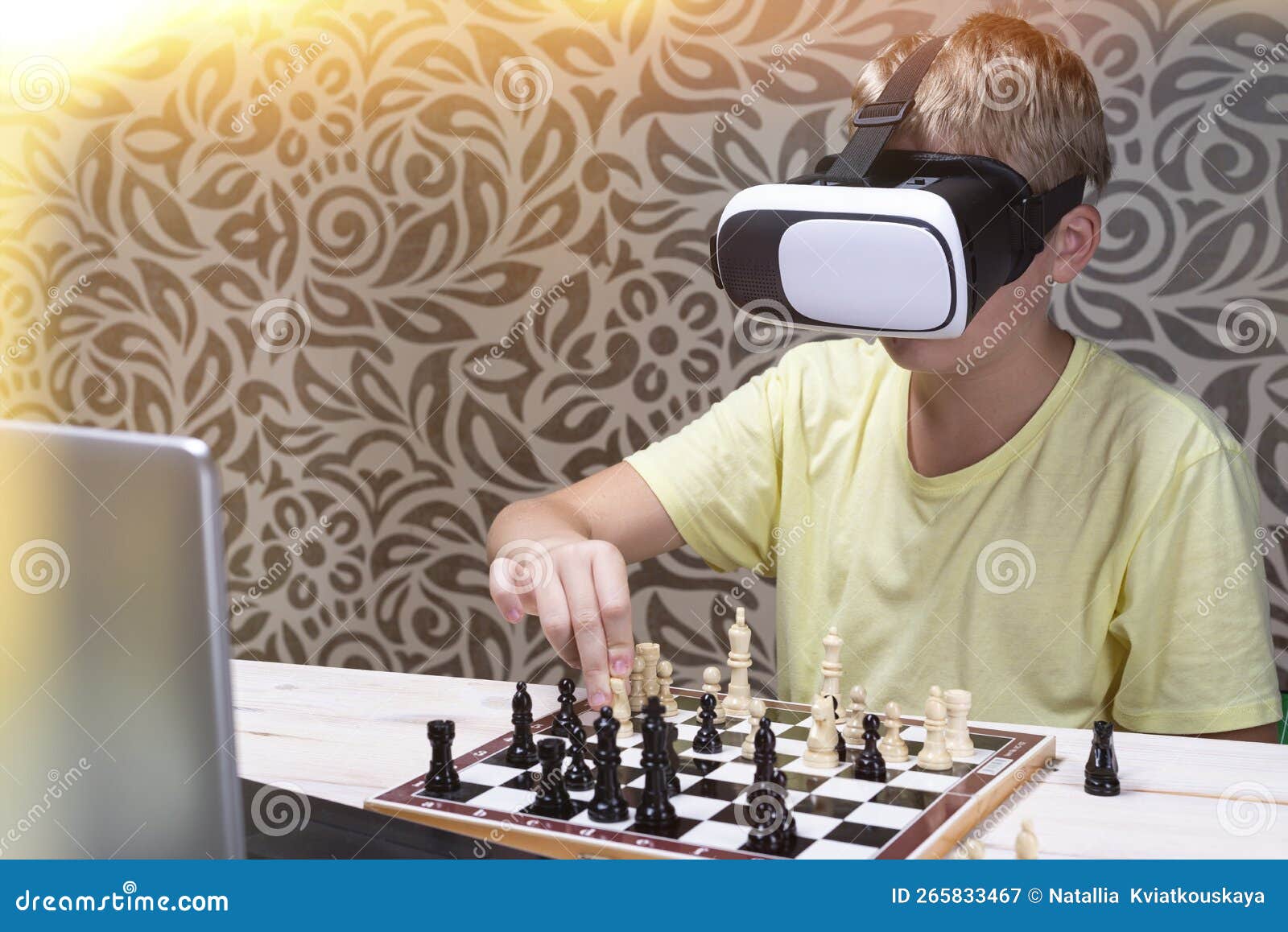 A Boy in a Virtual Reality Headset Plays Chess with a Laptop. Learning ...