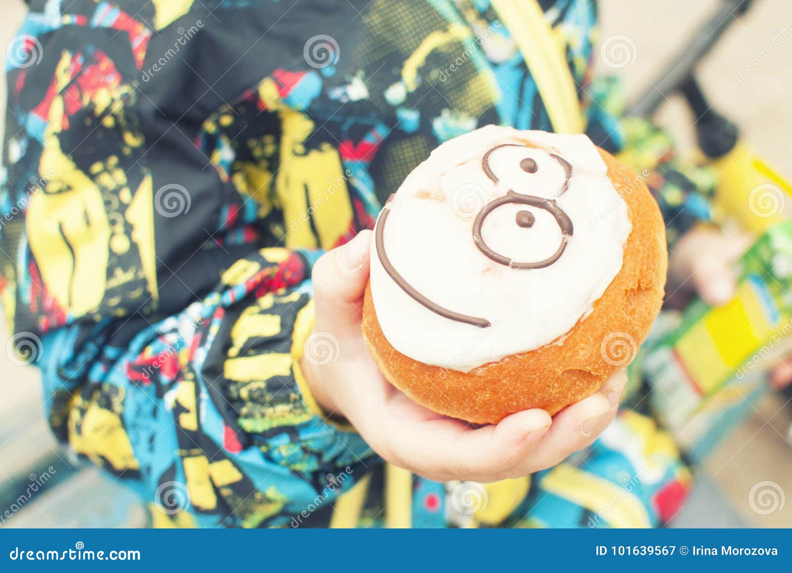 A Boy on a Walk Eats a Cake, a Smiley Face, Stock Image - Image of ...