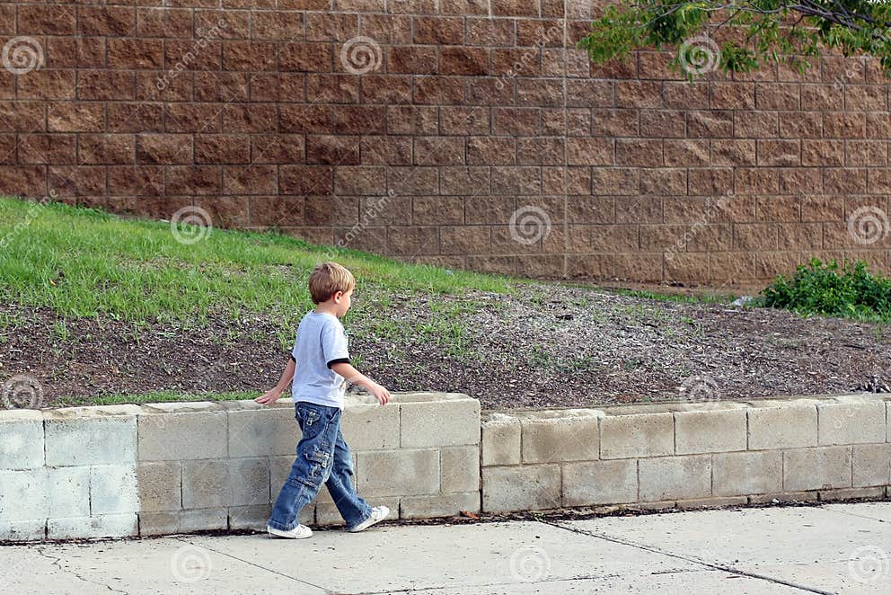 Boy walking on sidewalk stock image. Image of active, stroll - 7632053