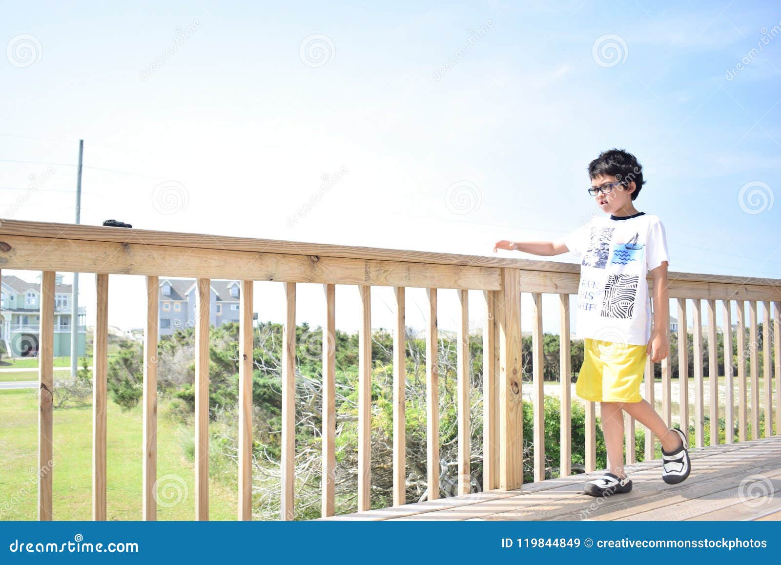 Boy Walking On Wooden Bridge. Picture Image: 119844849