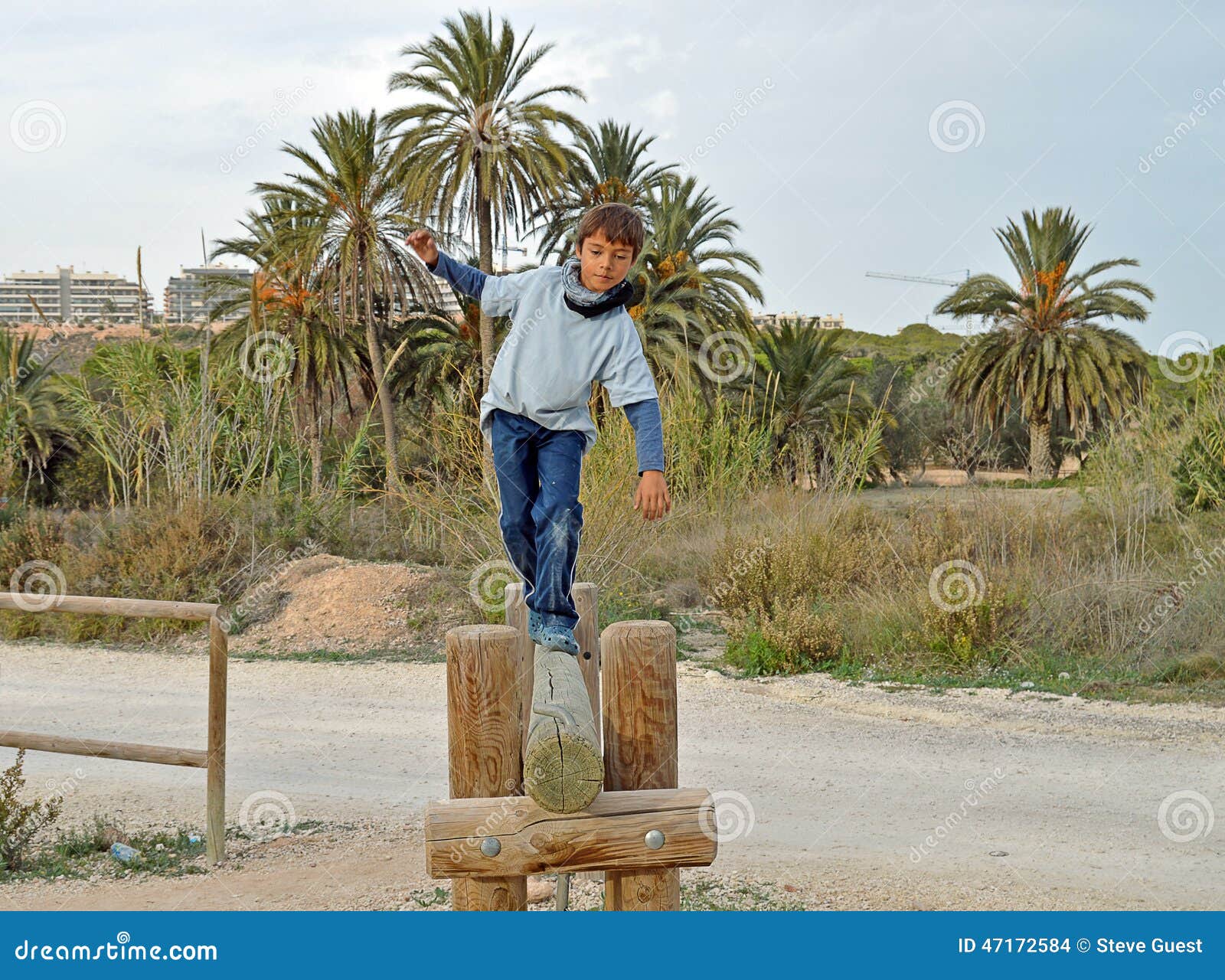 Boy Walking a Wooden Tightrope Stock Photo - Image of wooden, balance ...