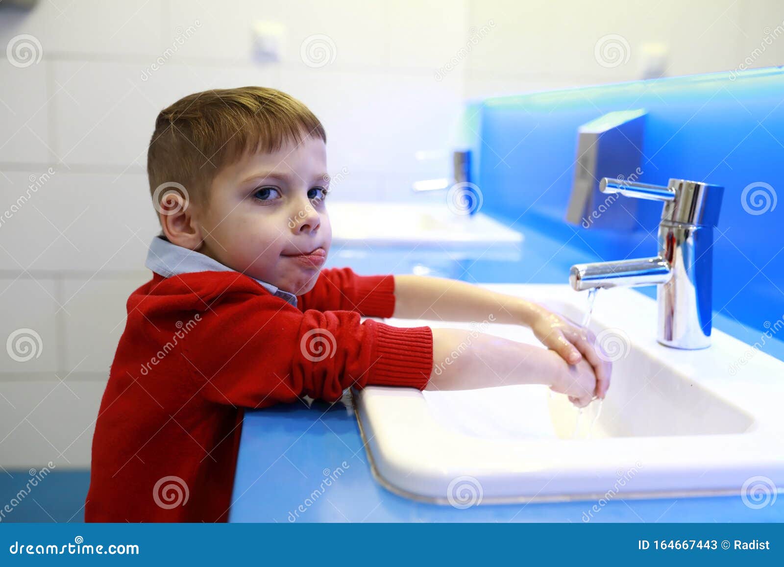 Boy washes his hands stock image. Image of beautiful - 164667443