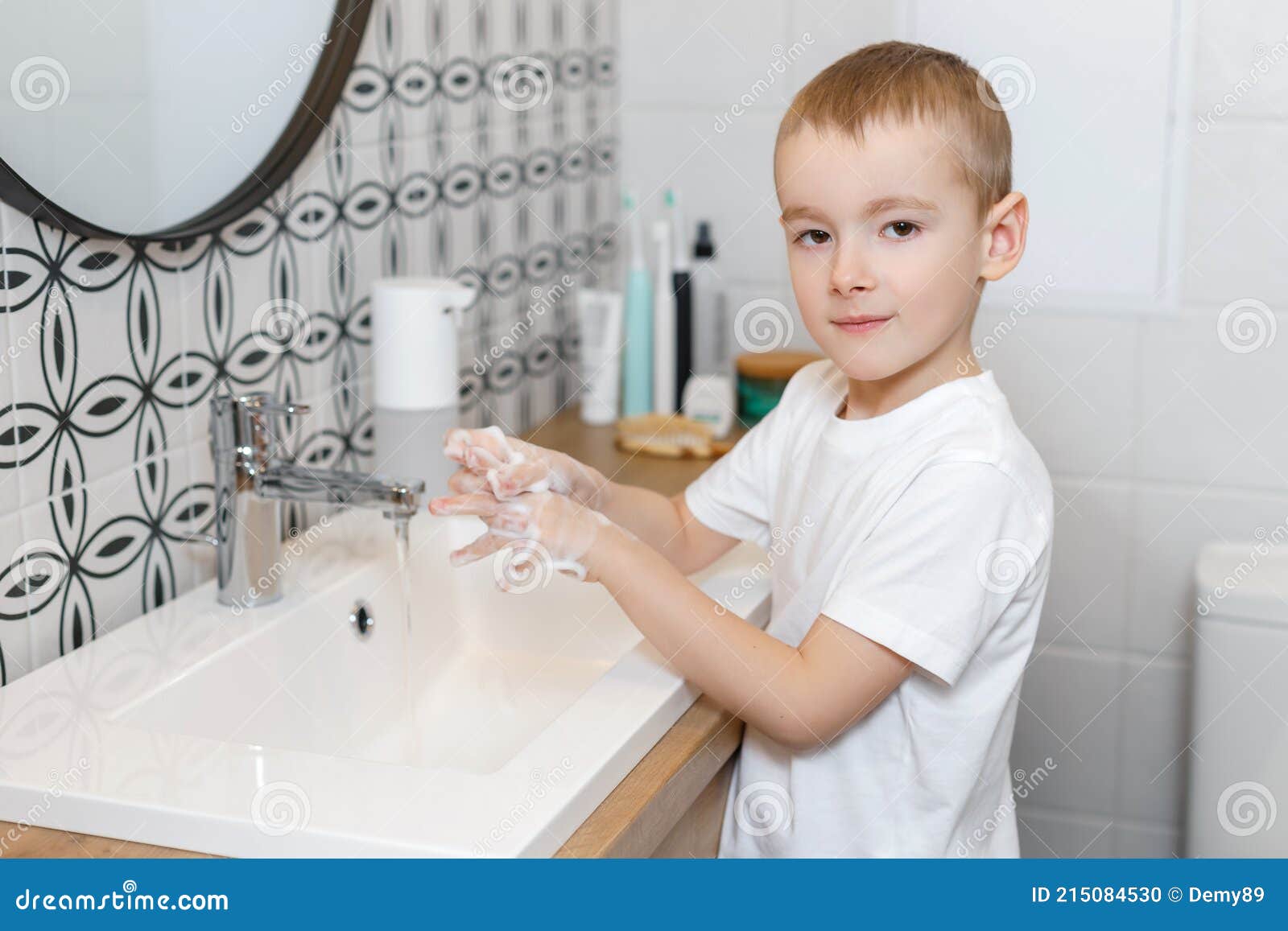 Boy Washing Hands in Bathroom Using Sensor Soap Dispenser Stock Photo ...