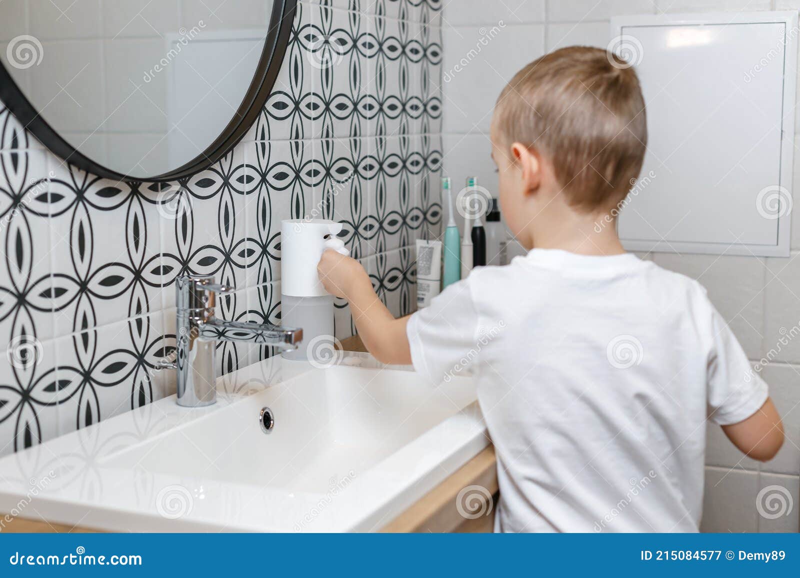 Boy Washing Hands in Bathroom Using Sensor Soap Dispenser Stock Image ...