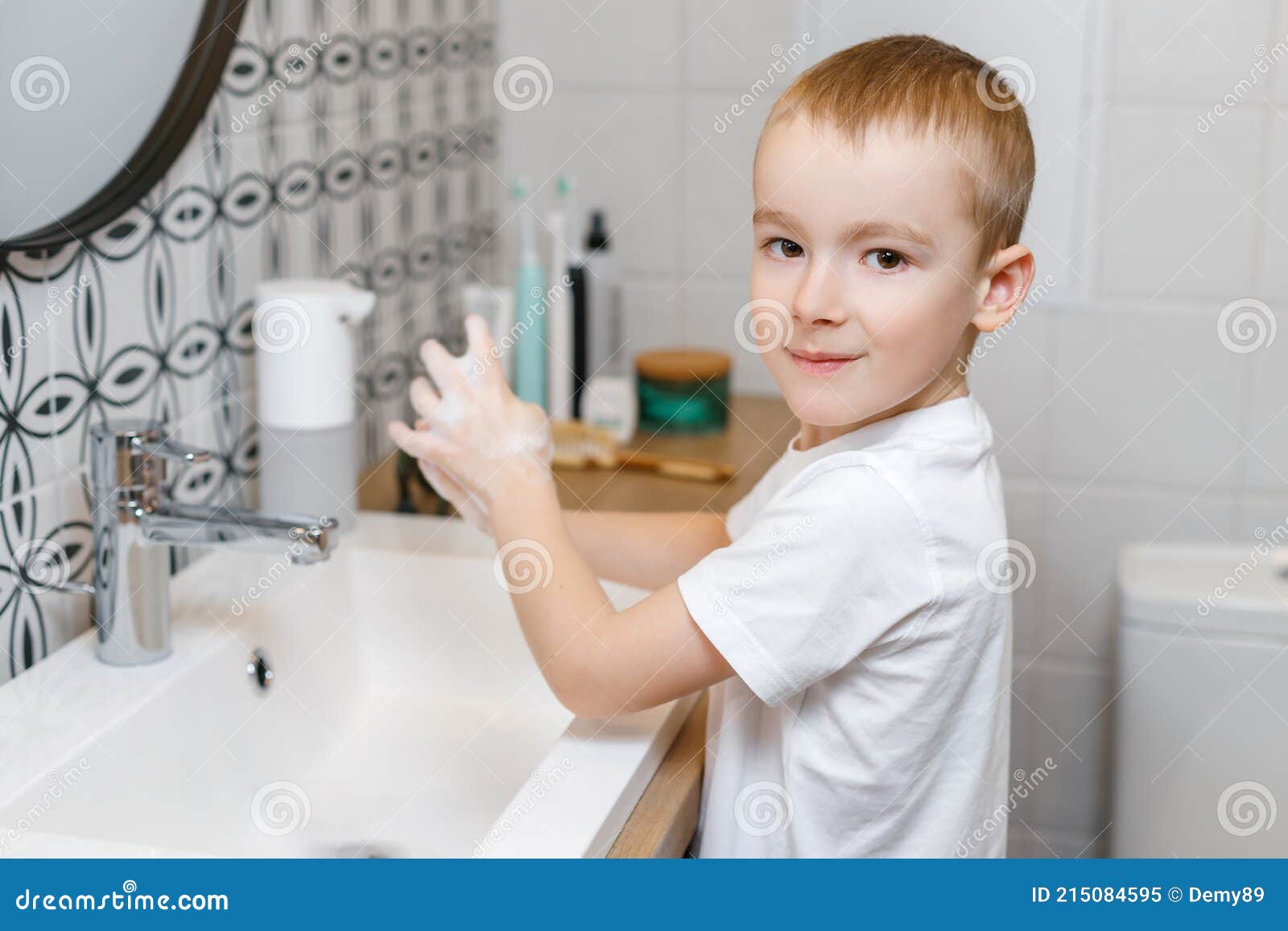 Boy Washing Hands in Bathroom Using Sensor Soap Dispenser Stock Image ...