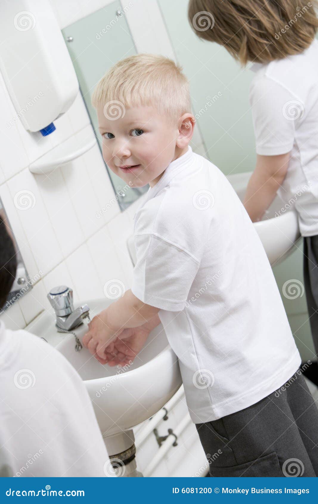A Boy Washing His Hands in a School Bathroom Stock Photo - Image of ...