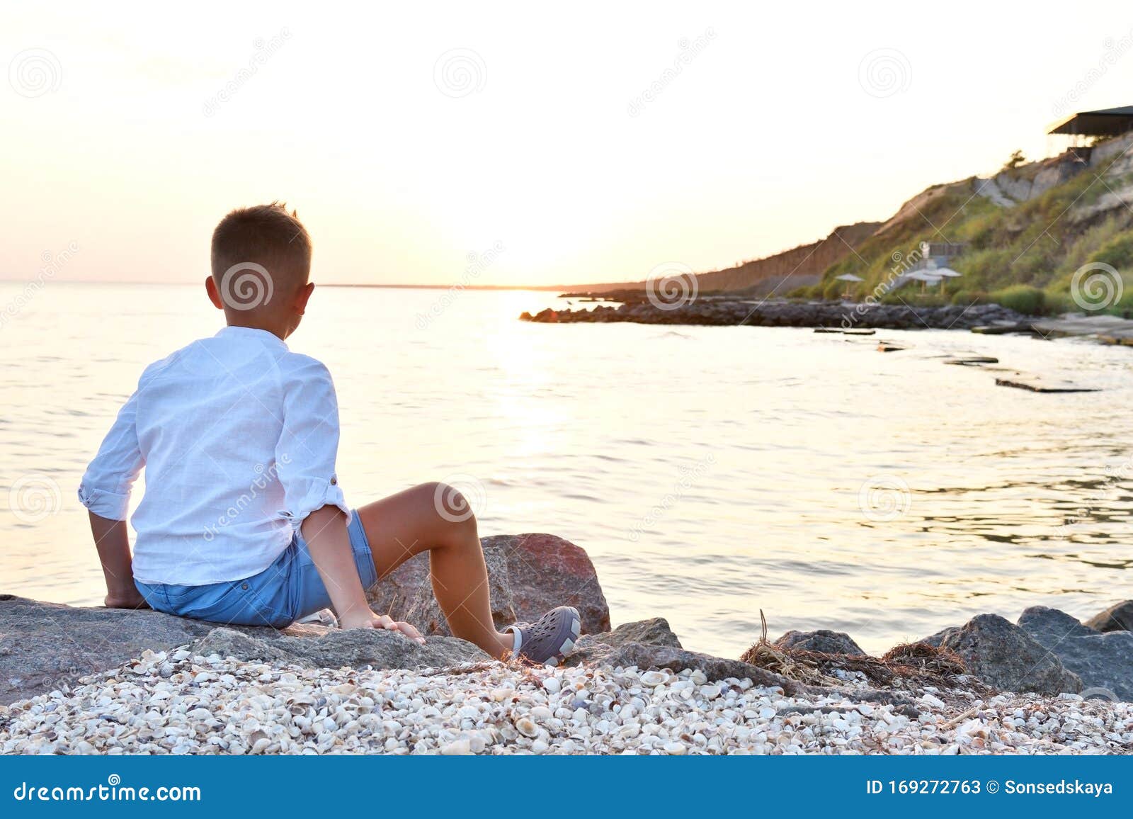 Boy watching the sunset stock image. Image of childhood - 169272763