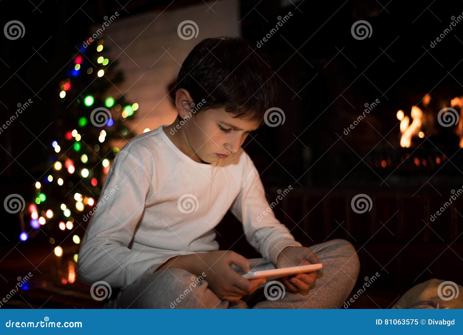 Boy Watching Tablet beside Christmas Tree a Stock Image - Image of ...