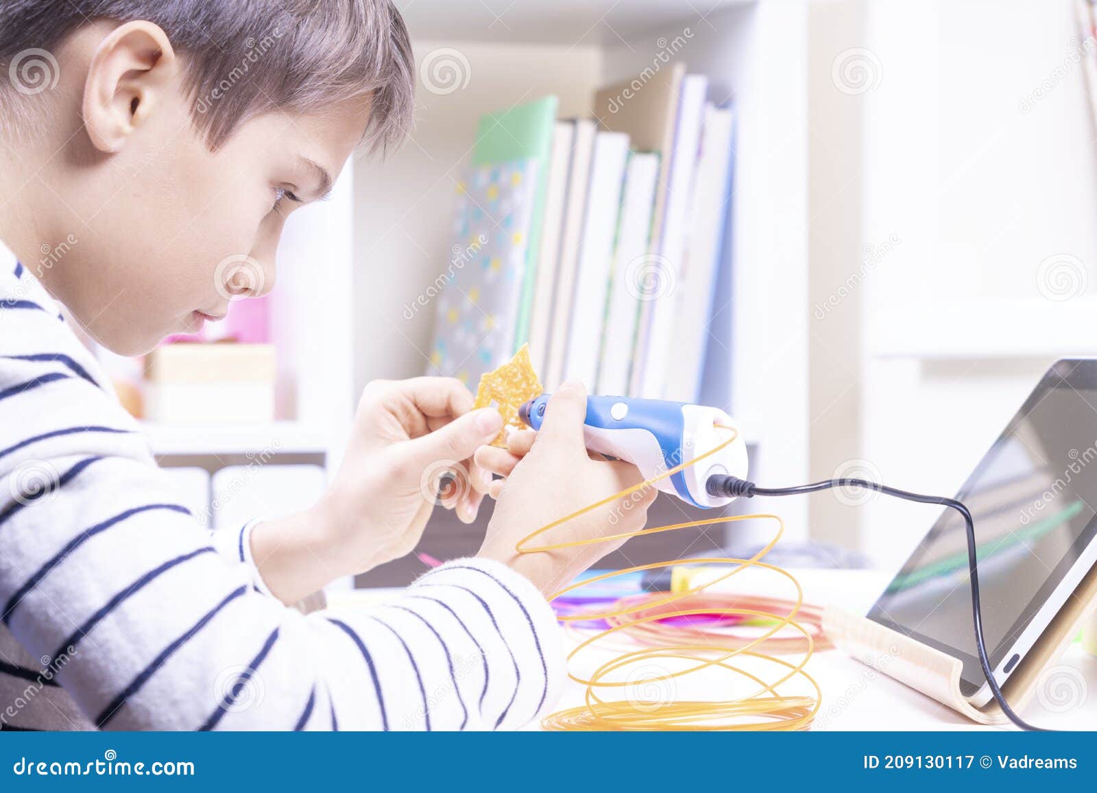 Boy Watching Video Tutorial on Tablet Computer and Creating with 3d Pen ...